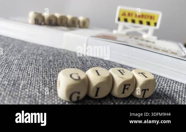 Selective focus on wooden blocks spelling gift with bribe and a warning ...