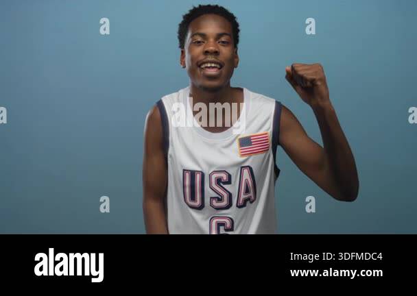 Man wearing usa basketball jersey with american flag patch smiles and ...