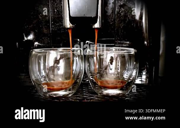 4K slow motion of coffee pouring into two cups from an Italian espresso ...