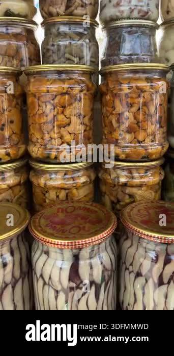 Different types of canned mushrooms in jars on a shelf. Forest, wild ...