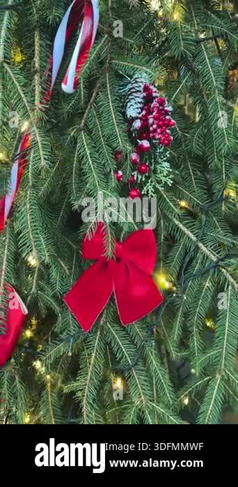 Green Christmas tree with Christmas, New Years decor: red bows, Candy ...