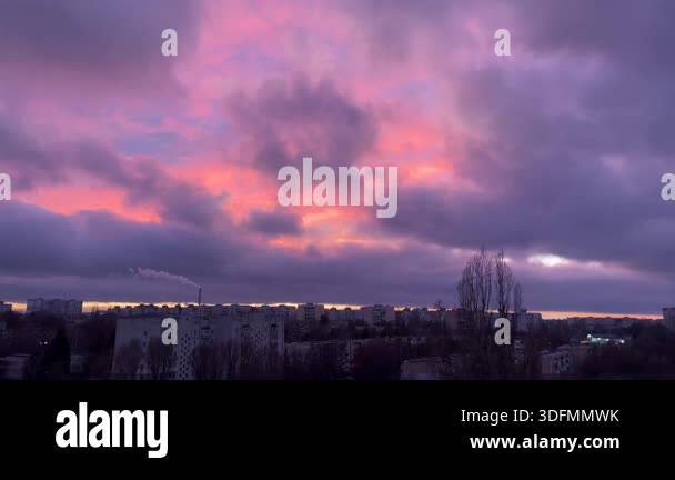 Bright pink-blue sky at sunset over a big city. At the bottom you can ...
