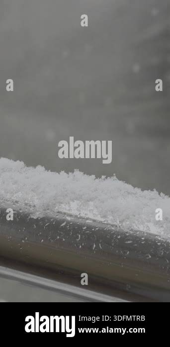Snowfall filmed from a house window with white snowflakes on the ...