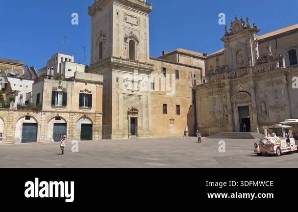 Lecce, Italy. Slow tilt shot of a historic bell tower and surrounding ...