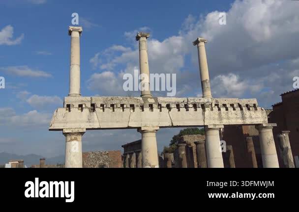 View of an ancient Roman colonnade in Pompeii, featuring tall stone ...