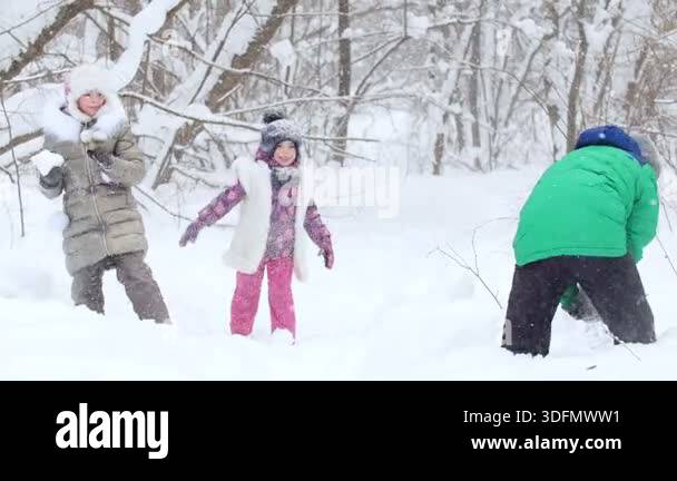Winter forest. Children standing in front of each other playing ...
