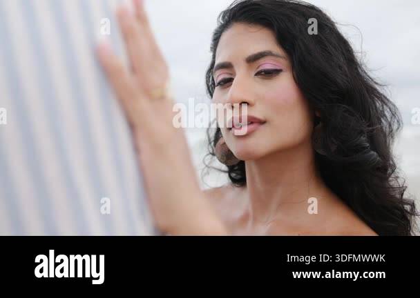 Beautiful woman with curly hair gently caressing a mans chest during a ...