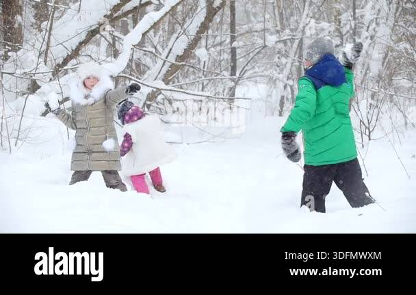 Winter forest. Happy children standing in front of each other playing ...
