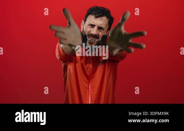 Hispanic man with a beard in an orange prison jumpsuit, wearing ...