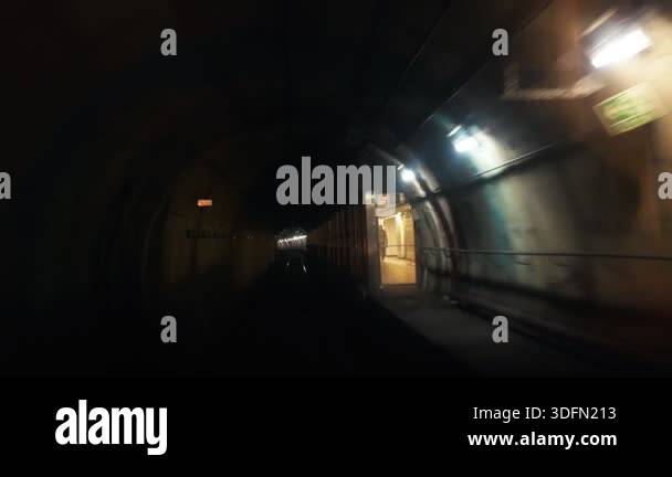 Shooting a subway train passing through a tunnel arriving at the ...