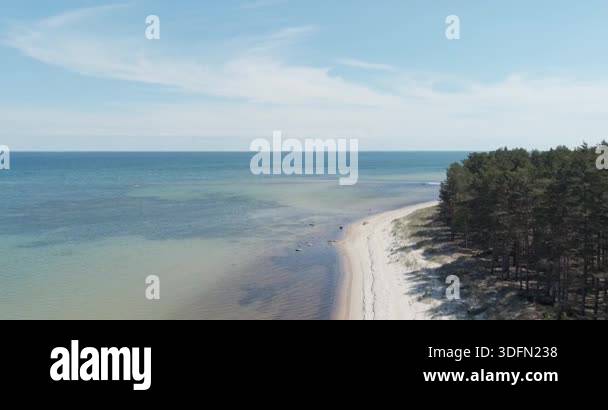 Aerial view of a natural coastline, featuring a long, sandy beach ...