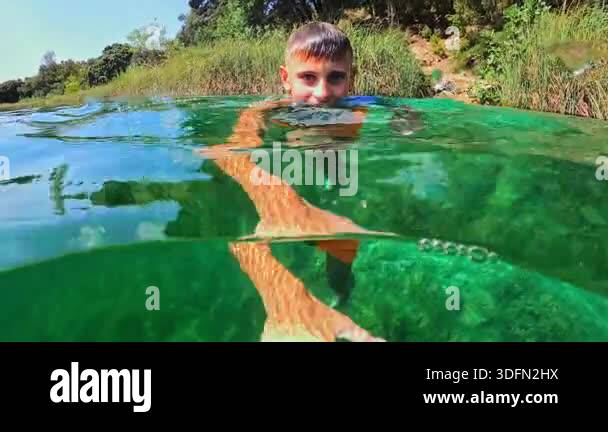 a boy with a diving mask in the water of the river Stock Video Footage ...