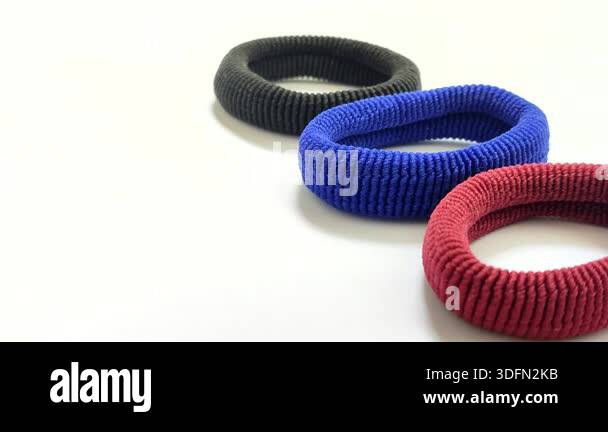 Three colorful elastic hair bands red, blue, and black isolated on a ...