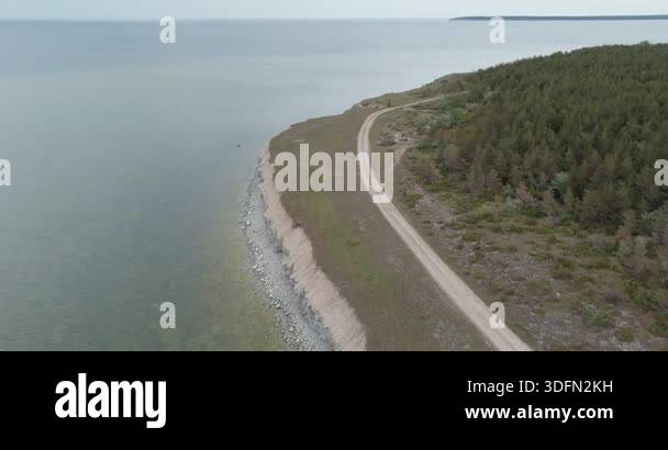 Aerial view of Ninase cliffs with unpaved dirt road running along the ...