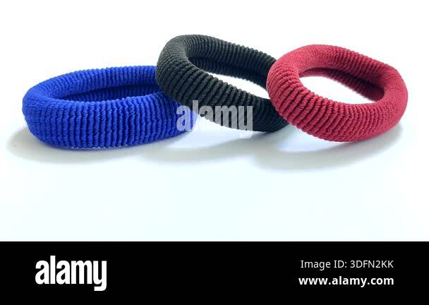 Three colorful elastic hair bands red, blue, and black isolated on a ...
