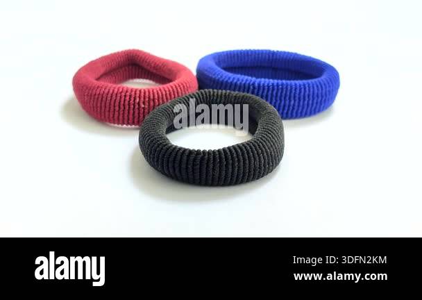 Three colorful elastic hair bands red, blue, and black isolated on a ...