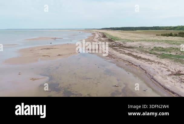 Aerial view of rocky coast, featuring shallow sandy beach bordered by ...