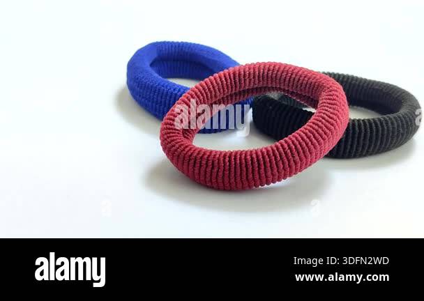 Three colorful elastic hair bands red, blue, and black isolated on a ...