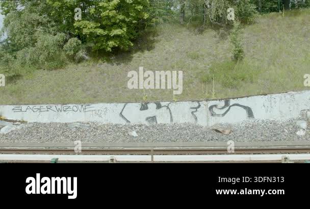Close-up of Helsinki Metro subway train passing by in summer, Kulosaari ...