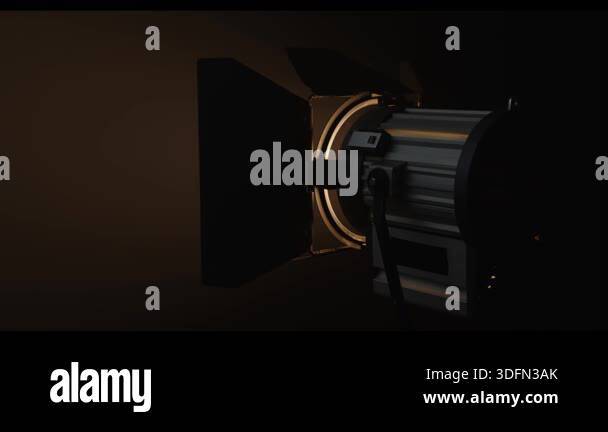 A professional spotlight for use in the dark, emitting a soft, warm ...