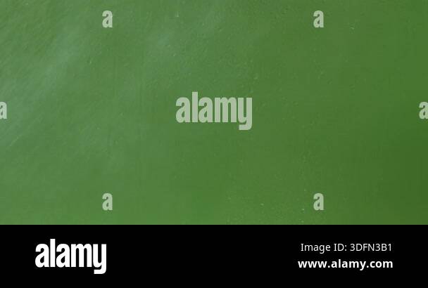 Close up of sprayed liquid and wet glass with water droplets and rain ...