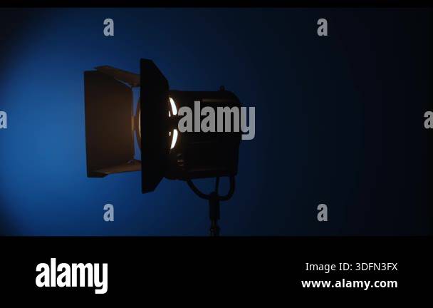 A spotlight with a soft, warm light is angled toward the camera ...
