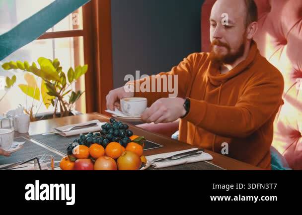 Family sitting in the hotel restaurant - a man and woman taking the ...