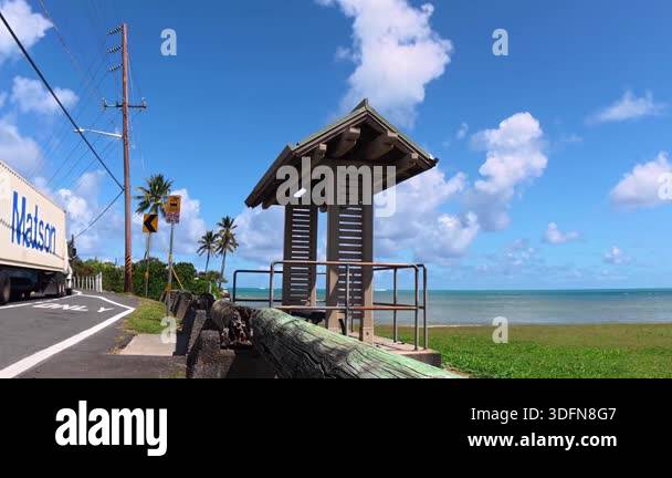 Static shot of a bus stop along Kaneohe Beach near Kualoa Ranch on Oahu ...