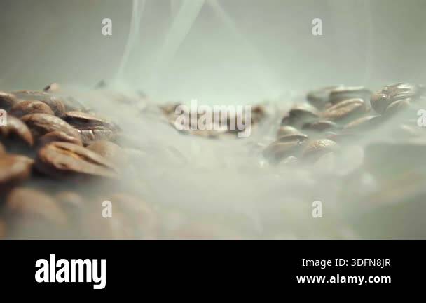 Flying closeup shot over freshly roasted coffee beans, light background ...