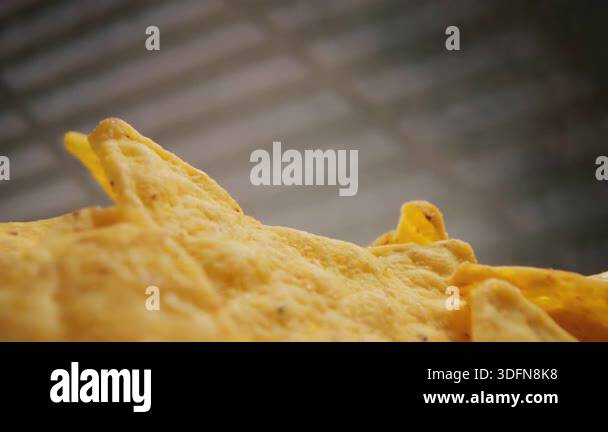 Corn chips close-up, mexican nachos, slow motion footage of crispy ...