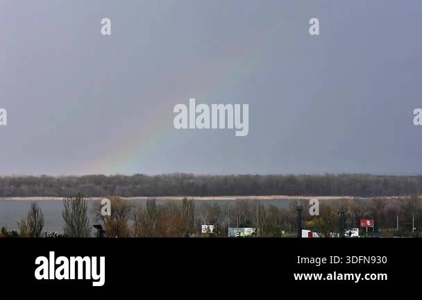 Rainbow over the river in winter time lapse, grey background Stock ...