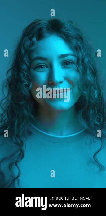 Happy Portrait of Young Woman Looking at Camera and Smiling in Neon ...