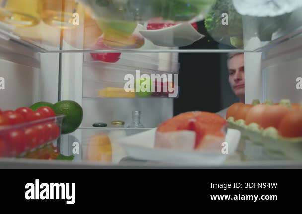 Man Opening Fridge Door with Healthy Food and Taking Products. Hungry ...