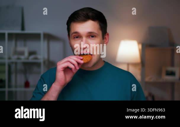 Portrait of Young Man Eating Sweet Food and Looking at Camera Close Up ...