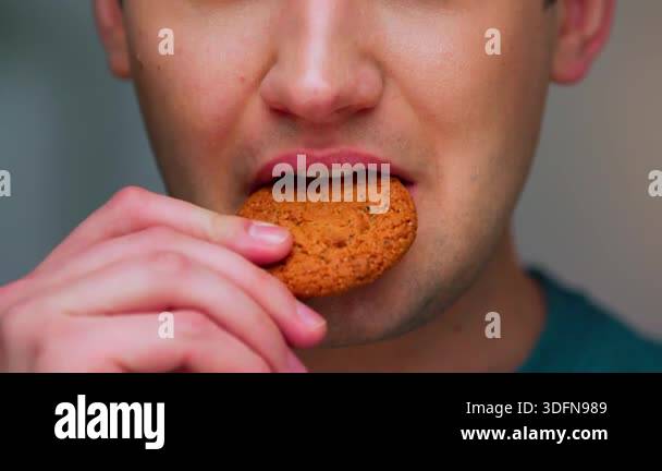 Portrait of Young Man Eating Sweet Food on Camera Close Up. Crop Face ...