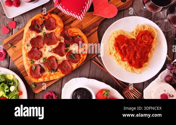 Home cooked Valentines Day dinner. Slow rotating zoom motion. Top view ...