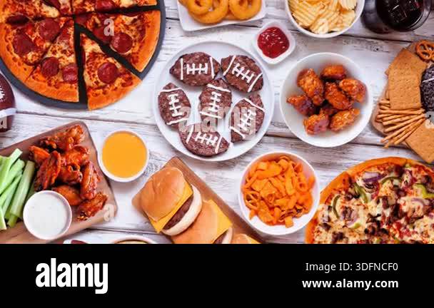 Super Bowl or football theme food table scene. Slow rotating zoom ...