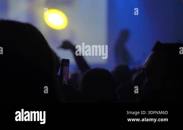 Orlando, Florida, USA - 08.17.2025: Silhouetted people stand in a ...