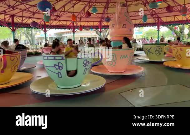 Orlando, Florida, USA - 05.06.2024: Guests ride the spinning teacups on ...