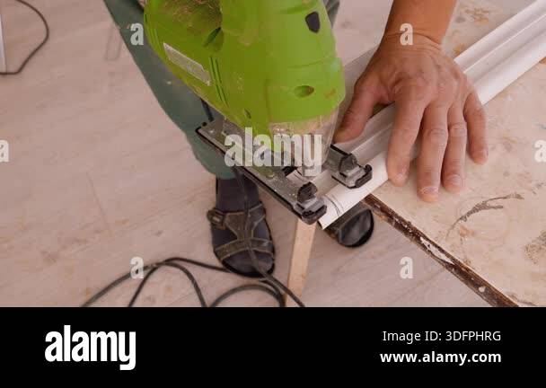 Skilled worker who works with an electric puzzle to accurately cut a ...