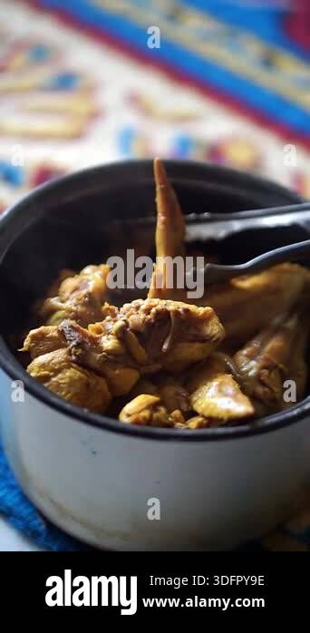 Serving process of boiled chicken wings using tongs, illustrating a ...