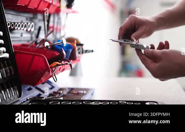 Serviceman Using A Vernier Caliper To Measure An Auto Part Against A ...