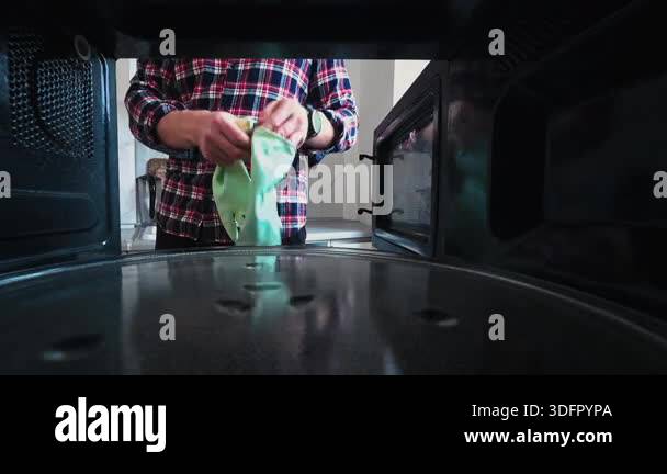 Man Wearing Protective Rubber Gloves Cleaning Inside A Microwave Oven ...