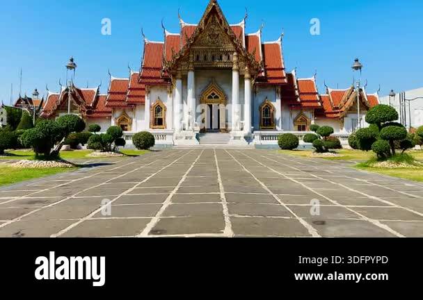 Wide-angle view of a traditional Thai Buddhist temple with ornate ...