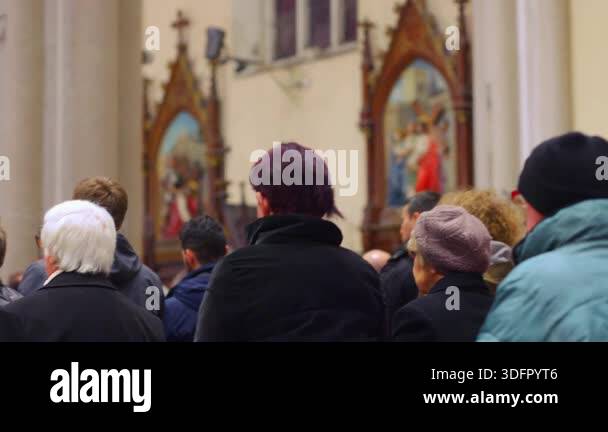 Holiday Catholic mass with parishioners captured from behind featuring ...