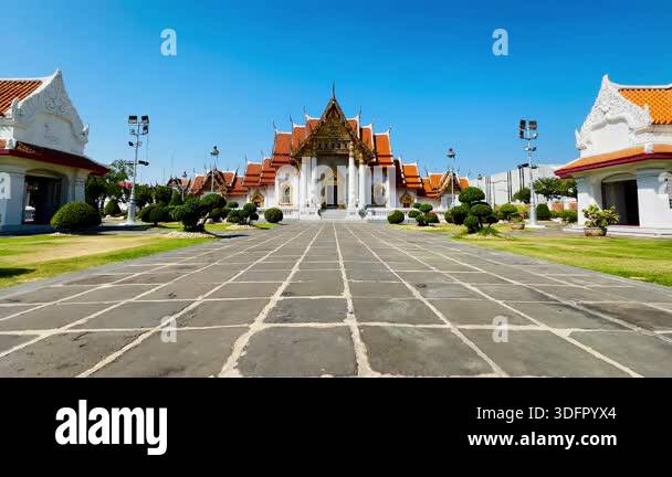 Wide-angle view of a traditional Thai Buddhist temple with ornate ...