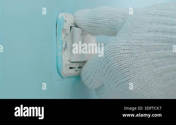 Close-up hand of man wearing cloth gloves and uses a screwdriver to ...
