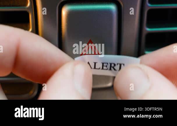 A sticker with the word ALERT is stuck on the Hazard Light Button in a ...