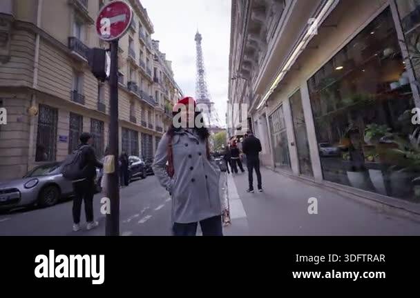 Handheld push toward an African millennial in a red beret on a Paris ...