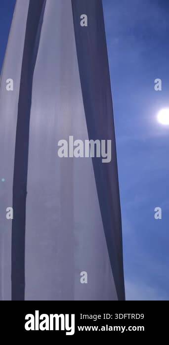A beautiful slow-motion shot of white satin fabric gracefully swaying ...